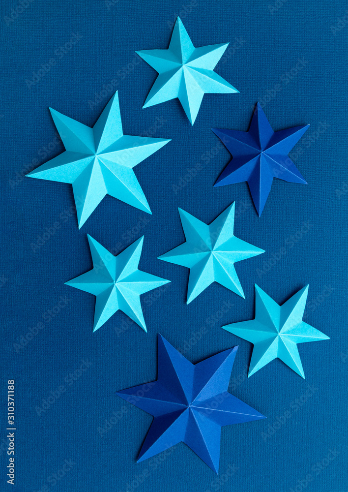Abstract background with colorful paper origami stars. Holiday ...