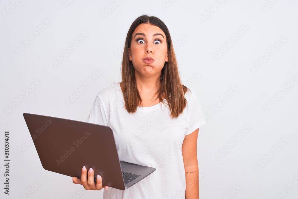 Beautiful young woman working using computer laptop over white ...