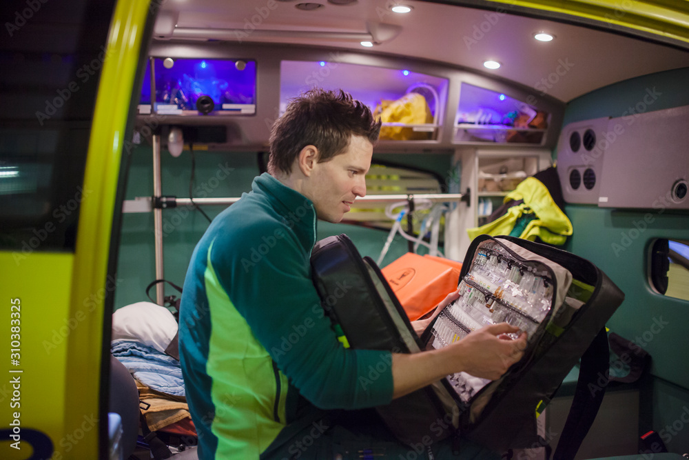 Paramedic in ambulance Stock Photo | Adobe Stock