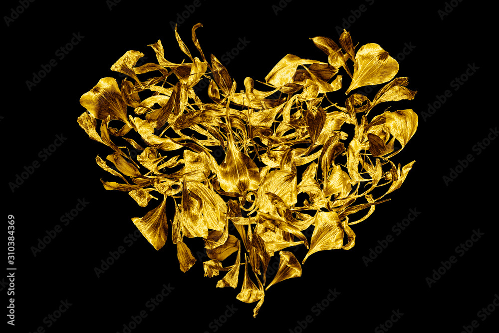 Golden heart made of flower petals on black background isolated closeup ...