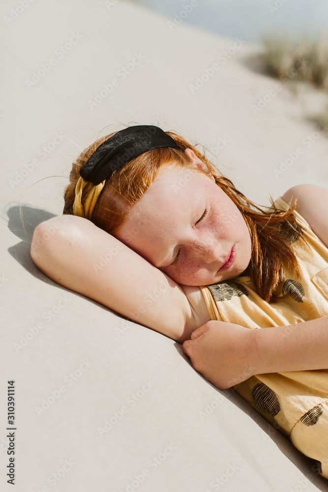 Girl sleeping on sand Stock Photo | Adobe Stock