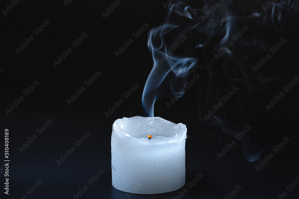 Smoke rising from a dipped candle. Blue smoke of a candle in dark ...