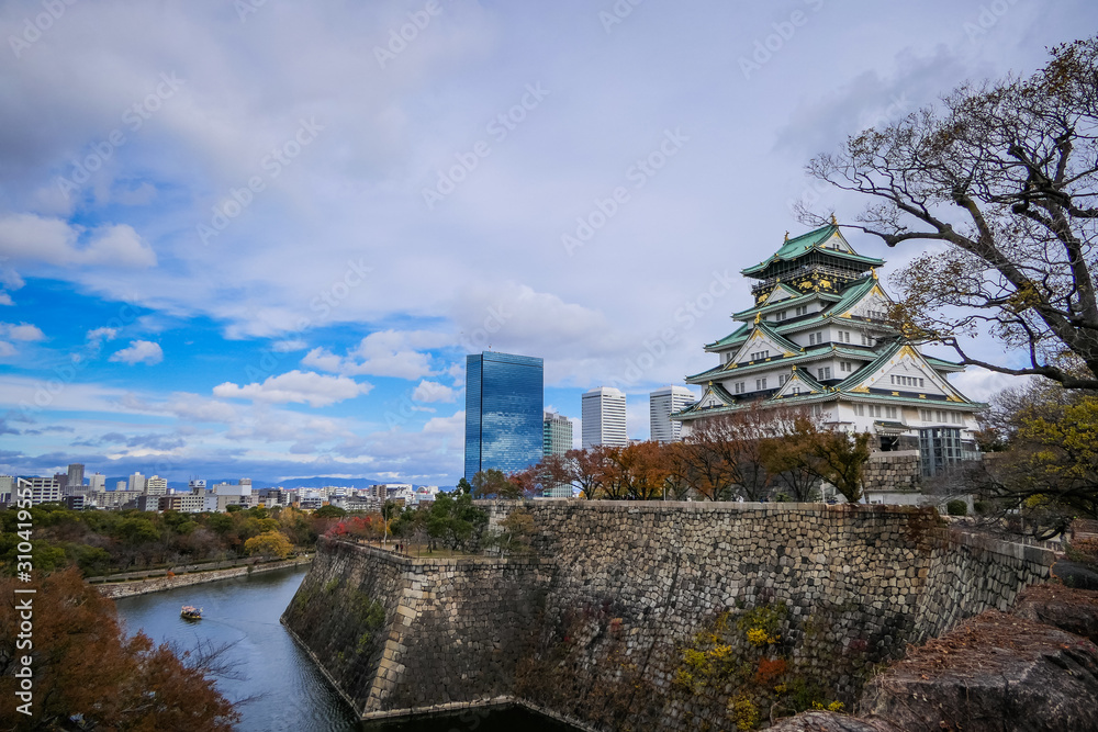 Osaka castle surrounded by the stones’ sheer walls with modern building ...