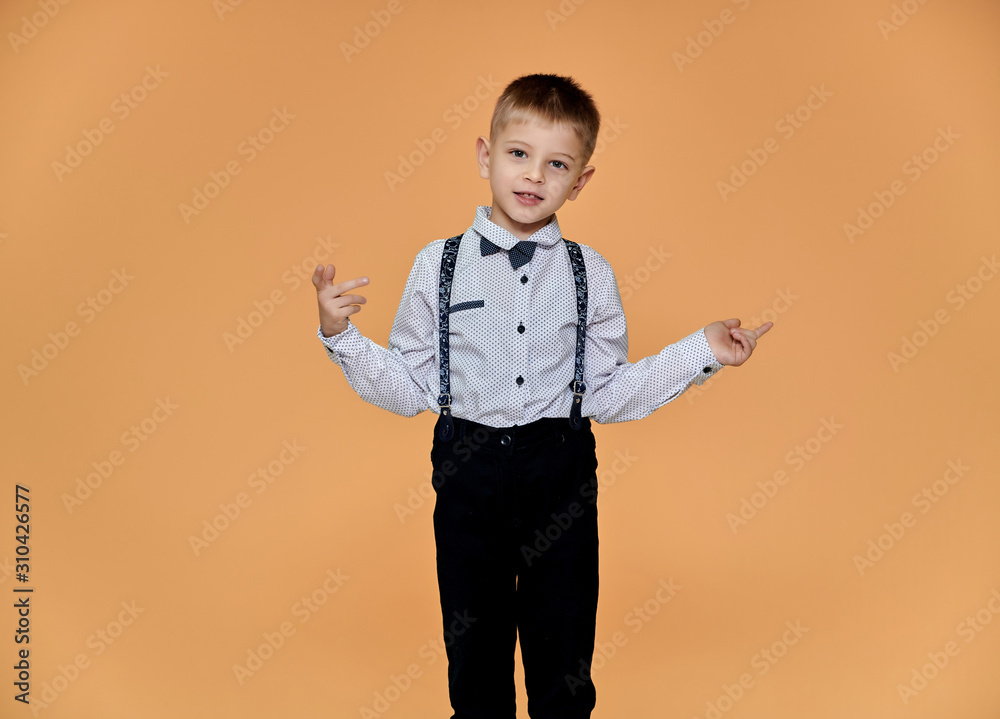 Portrait of a cute boy 10 years old schoolboy on a beige background in ...