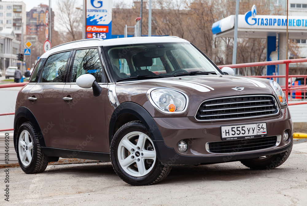 An expensive car, a female model of a mini cooper countryman beige and ...