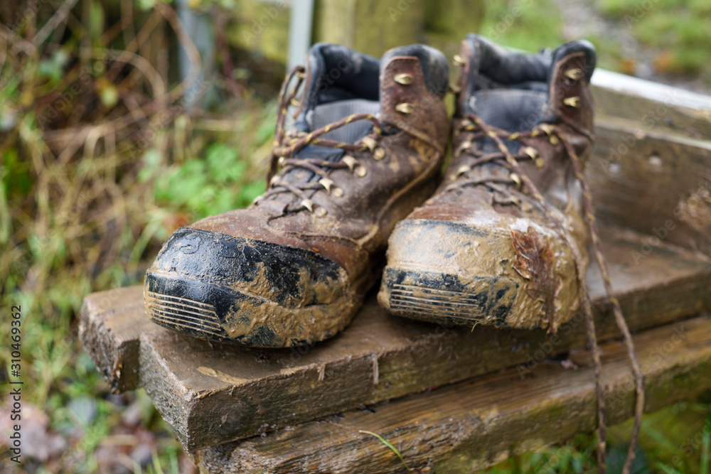 Muddy Hiking Boots in a countryside setting . Stock-Foto | Adobe Stock