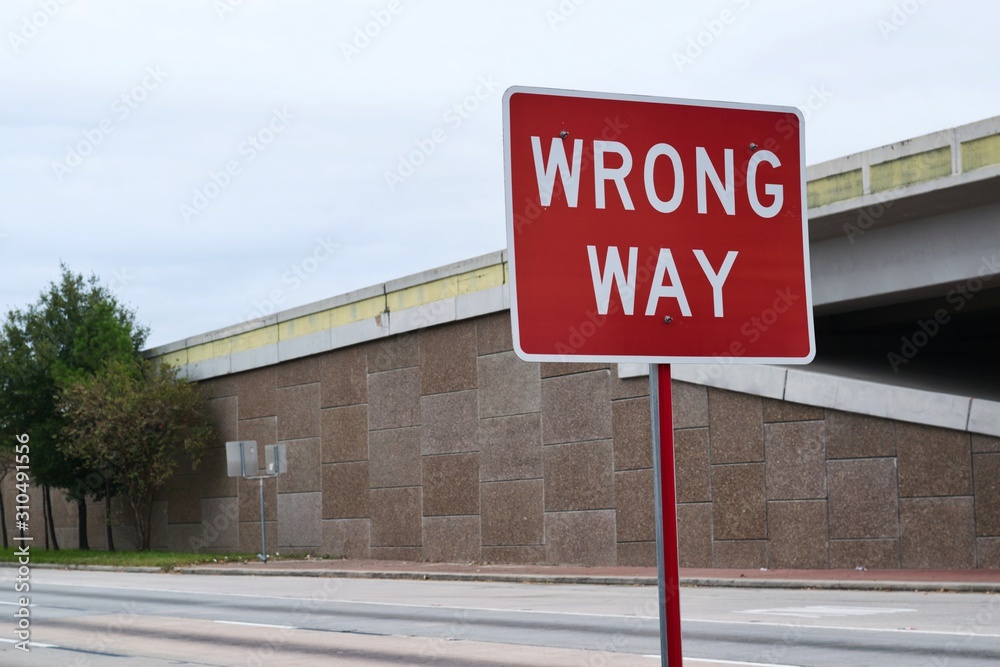 Wrong Way sign by freeway overpass city roads, safety law danger ...