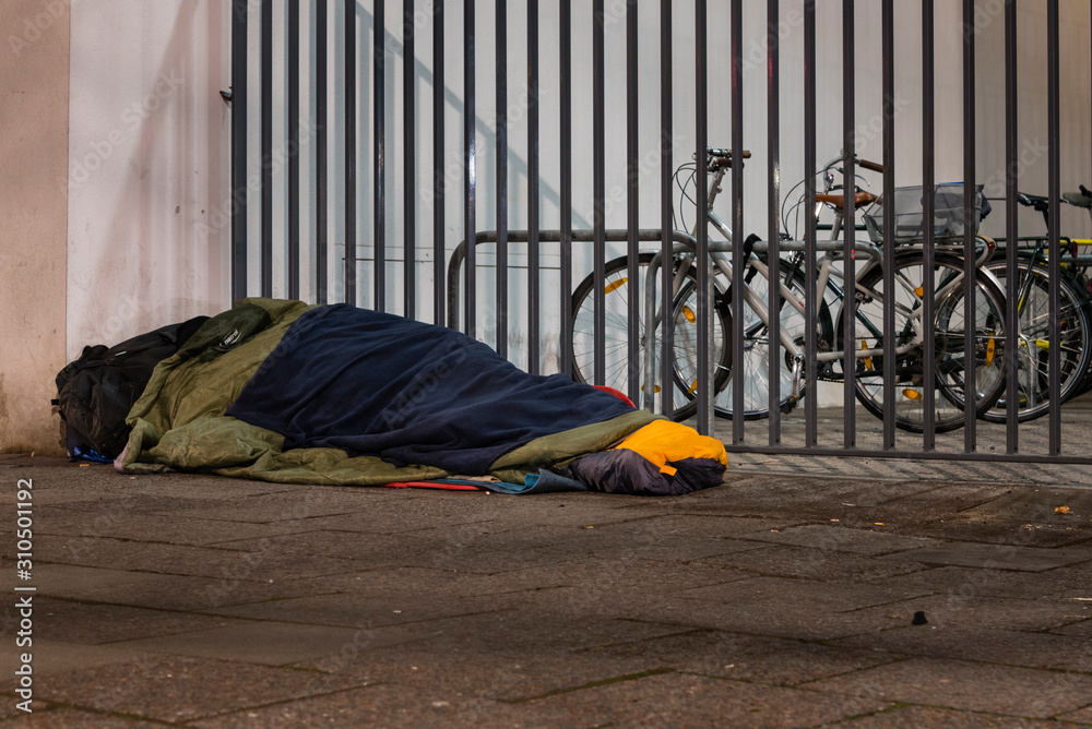 Homeless man sleeping in winter, homeless man in sleeping bag on the ...
