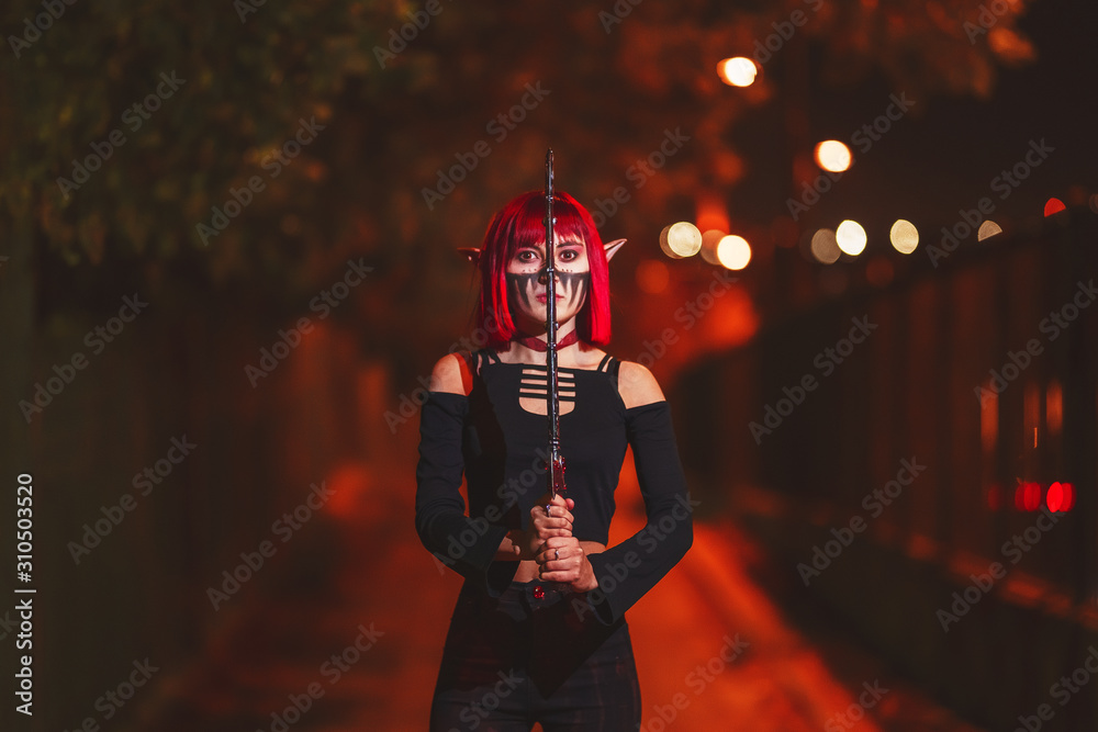 Girl cosplay in the image of a dark elf in a red wig with a sword on ...