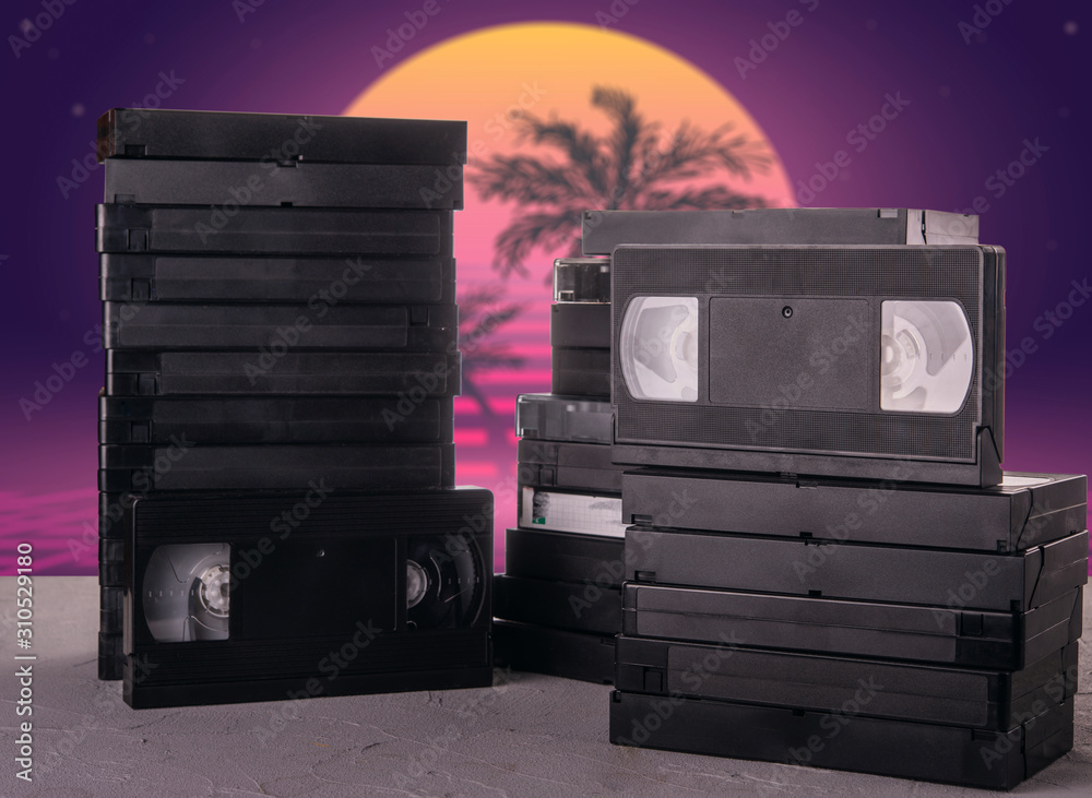 Collection of VHS videocassettes on a table with vintage background ...