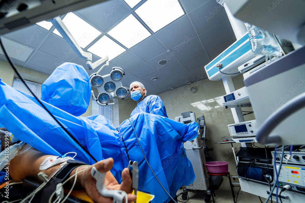 pulse oximeter on finger of patient during surgery operation. male ...