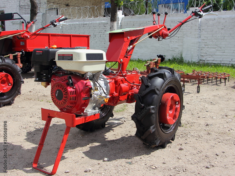 New red two wheel walk-behind mini tractor with four stroke air cooled ...