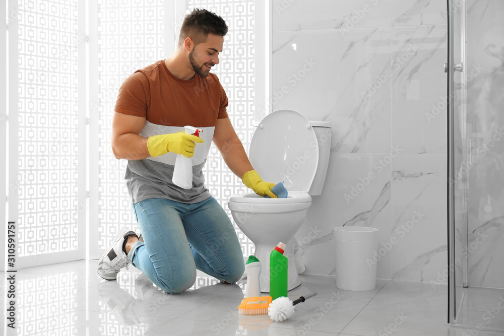Man Cleaning The Bathroom
