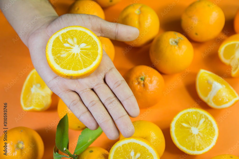 person placing fresh juicy and pulpy orange round slice in hand top ...