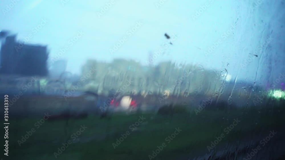 Raindrops on the window. Railway. The train passes under the bridge ...