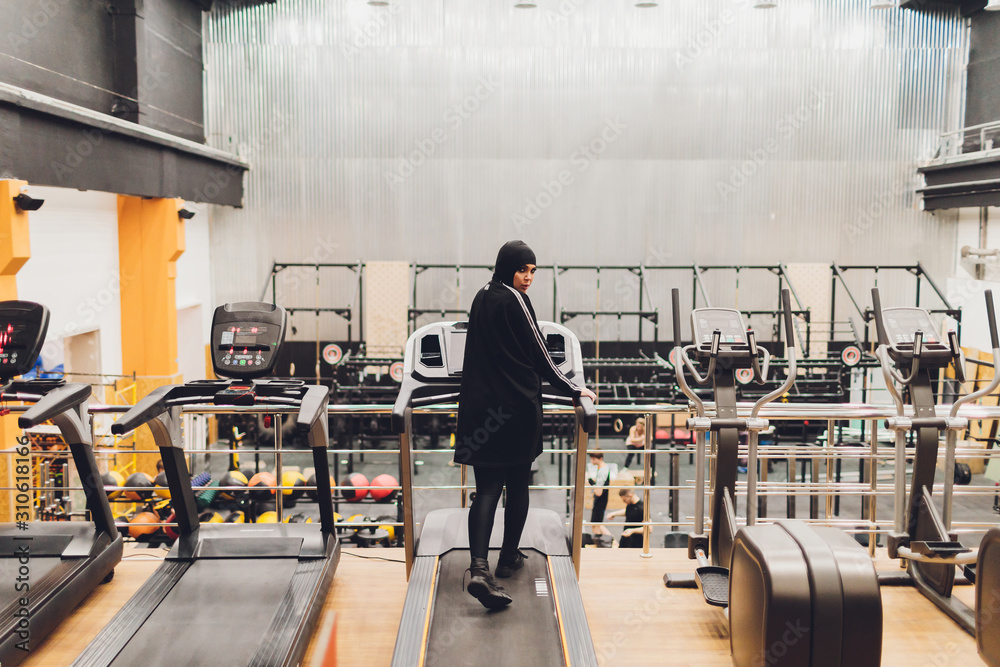 Muslim asian woman in hijab exercizing in a gym. Stock Photo | Adobe Stock