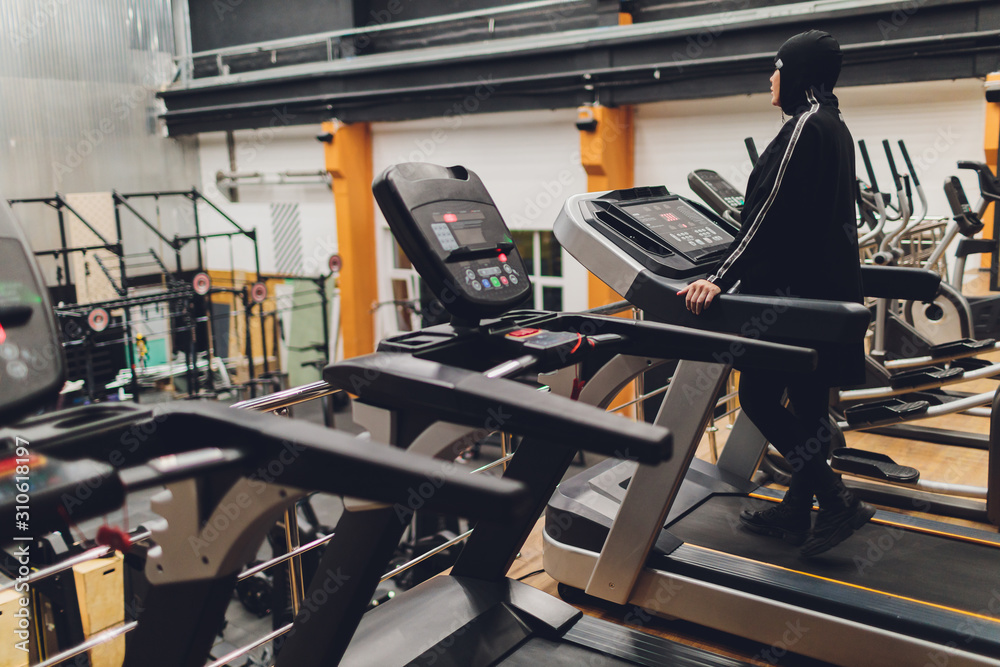 Muslim asian woman in hijab exercizing in a gym. Stock Photo | Adobe Stock