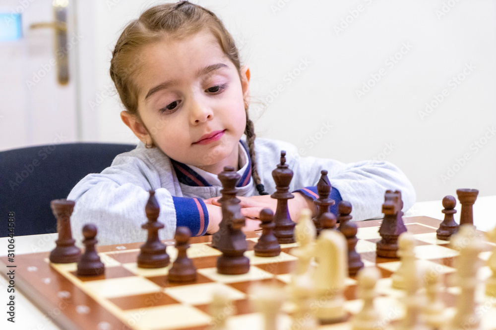 Little girl playing chess at home. Games and activities for children ...