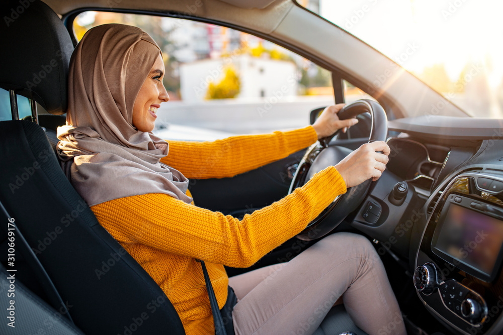 Young attractive smiling arab woman in traditional wear trying out new ...