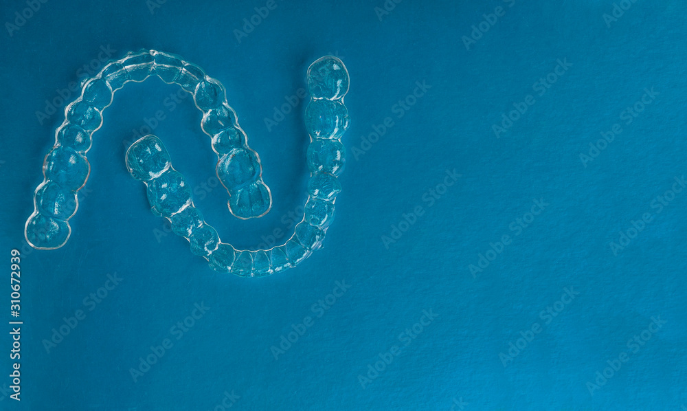 Invisible dental teeth brackets tooth aligners on trendy blue ...