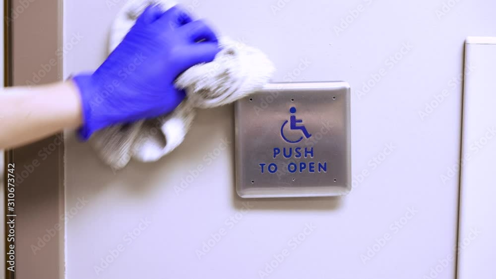 Janitor cleaning Handicap push to open button on wall in doctors office ...