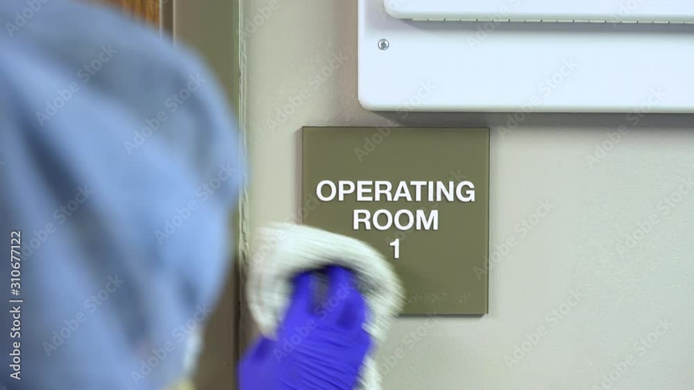 Vídeo do Stock: Female janitor cleaning brail sign for operating room 1 ...
