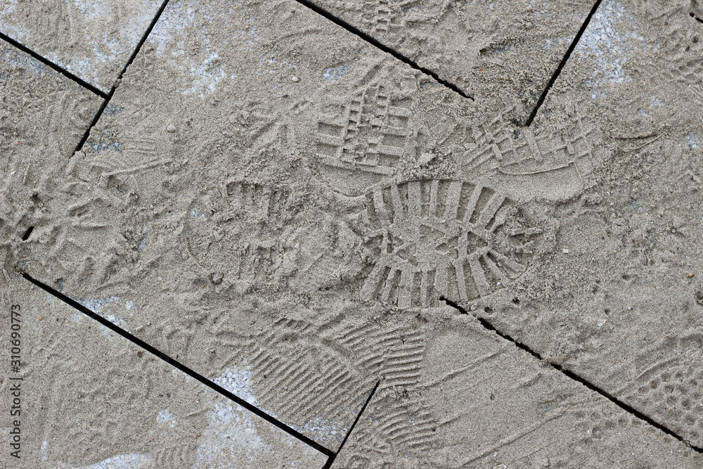 Footprints and markings on sand covered new pavement tiles Stock-Foto ...