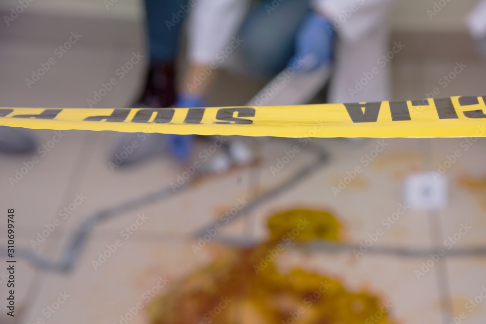 Forensic technicians taking DNA sample from blood stain with cotton ...