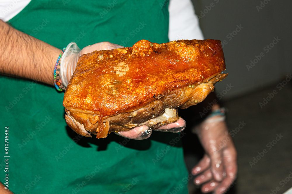 Crispy juicy roasted pork barbecue meat locally called “capriko” on ...