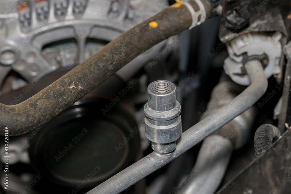 Closeup of automotive air conditioner high pressure side service port ...