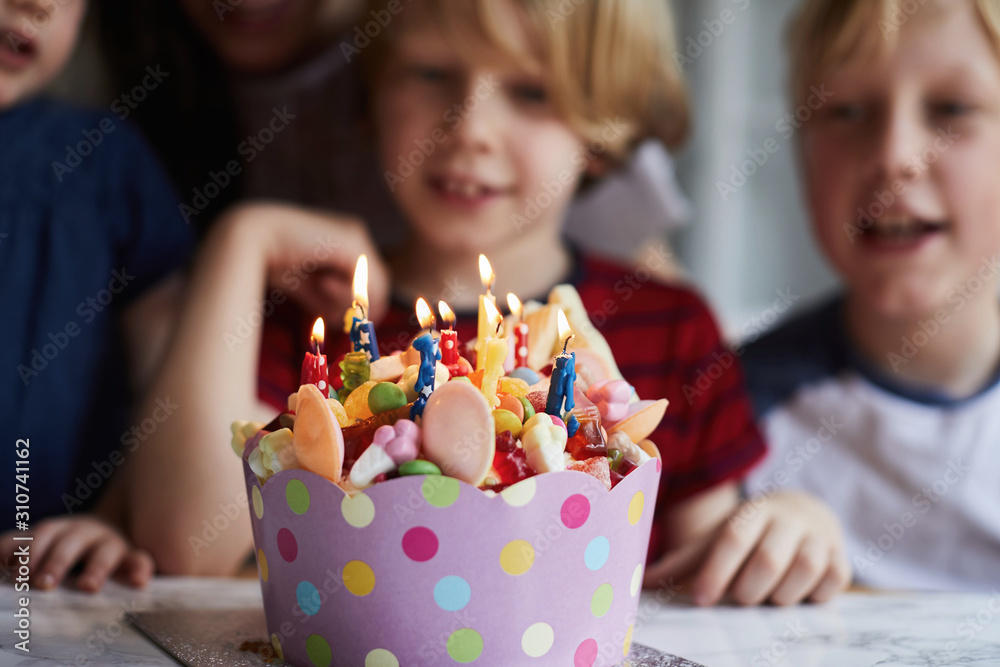 Children around a birthday cake Stock Photo | Adobe Stock