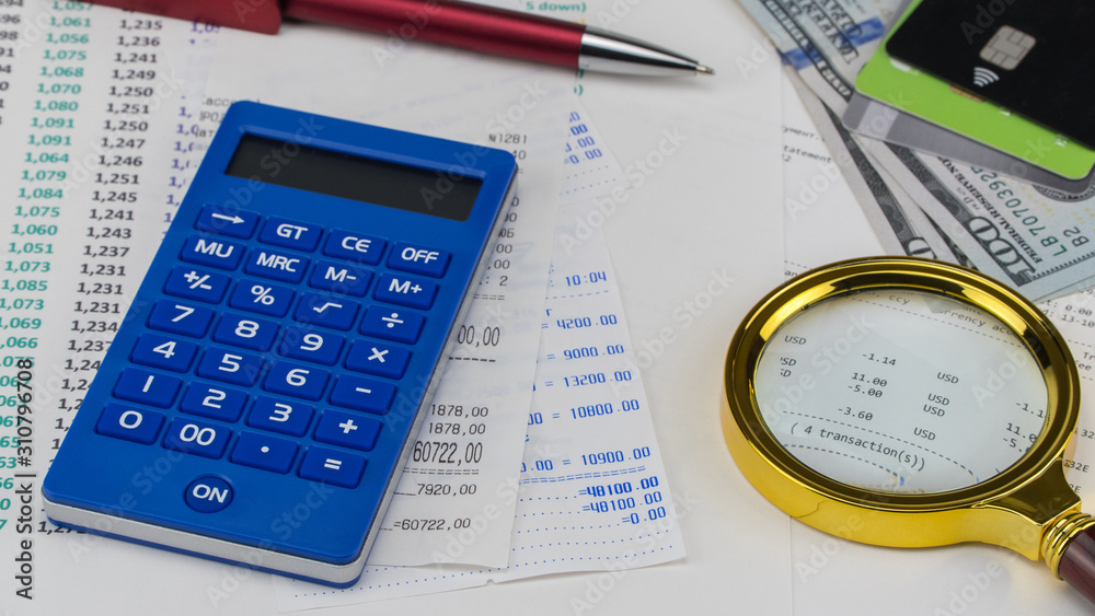 Calculator and us dollars on top of supermarket receipt. Shopping and ...