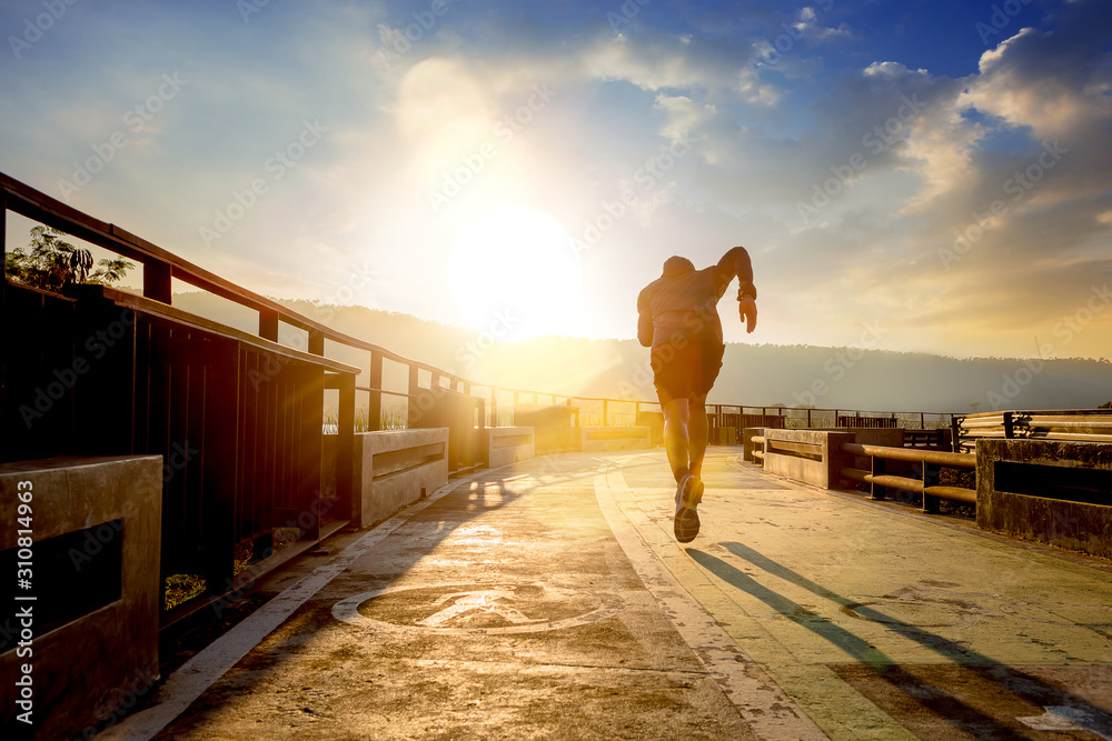 Silhouette of man running sprinting on walk way. Fit male fitness ...