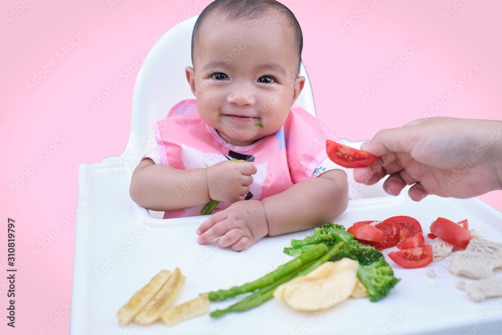 Cute Asian baby girl eating by hands, Little baby eating organic ...
