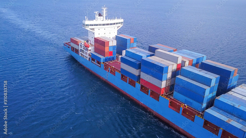 Large container ship at sea, loaded with various container brands. ULCV ...