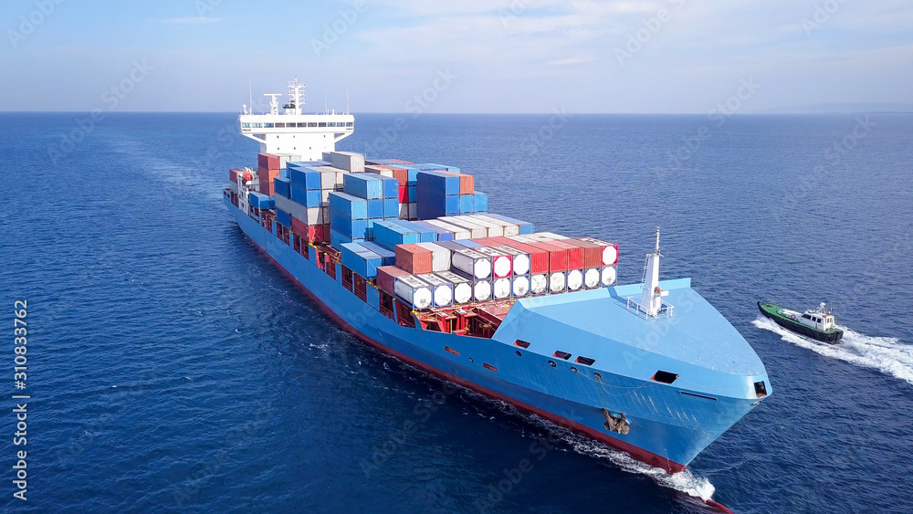 Large container ship at sea, loaded with various container brands. ULCV ...