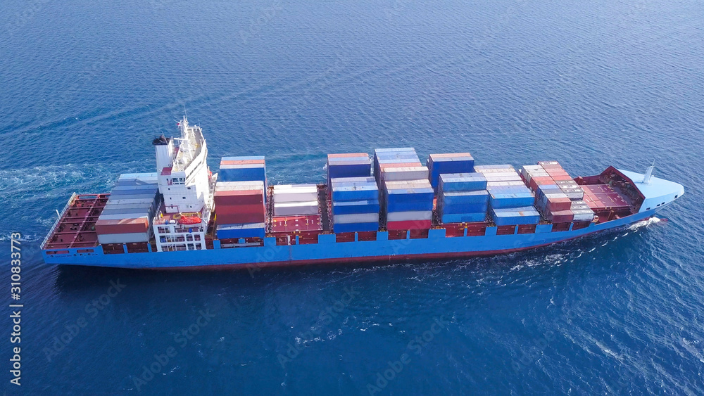 Large container ship at sea, loaded with various container brands. ULCV ...