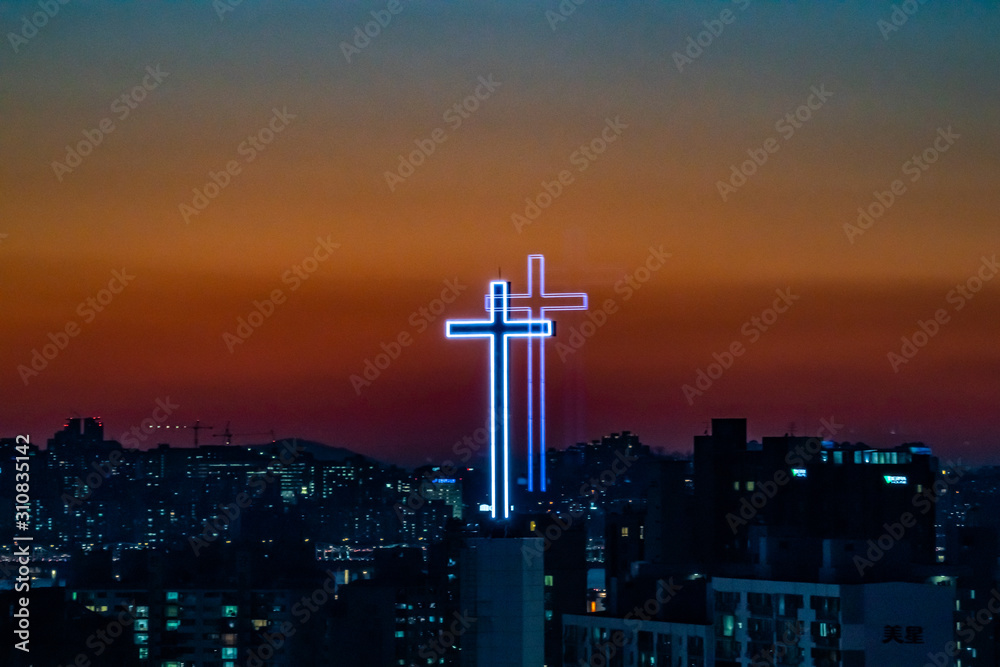 Church Cross with sunset background, viewed through the window. The ...