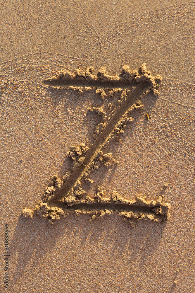 Alphabet (z) letters handwritten in sand on beach Stock Photo | Adobe Stock