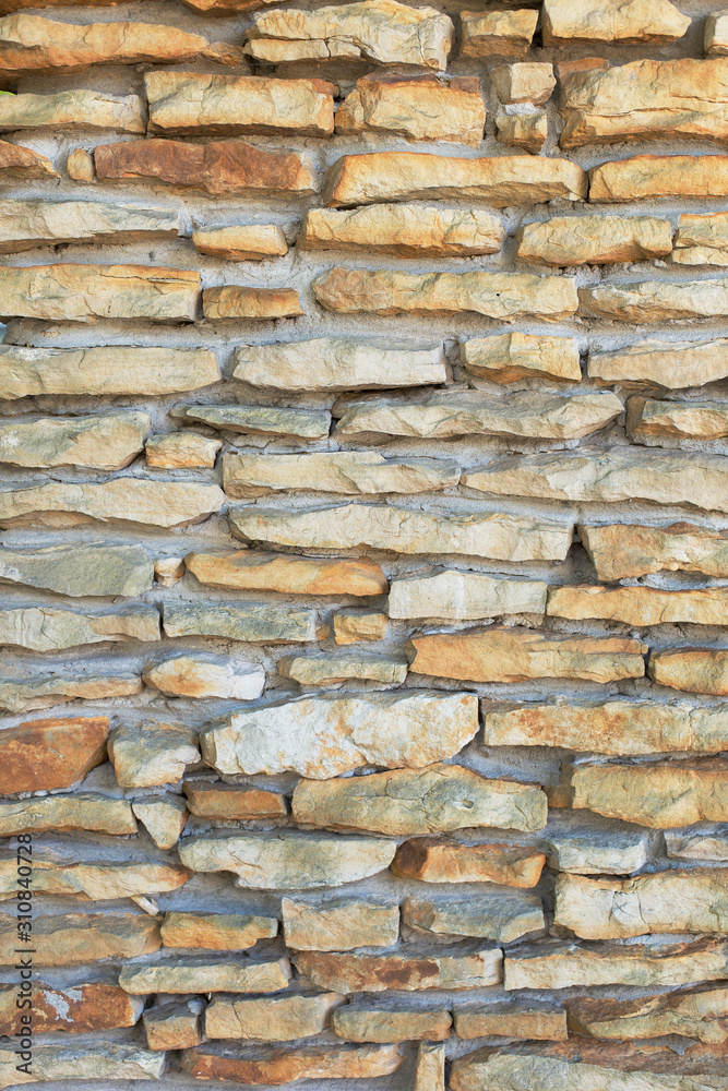 Part of a wall made of fine natural processed stone. Beautiful stone ...