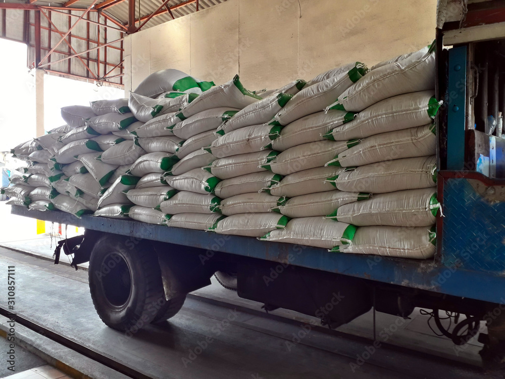Ten wheel truck loading sack goods to customers. Stock Photo | Adobe Stock