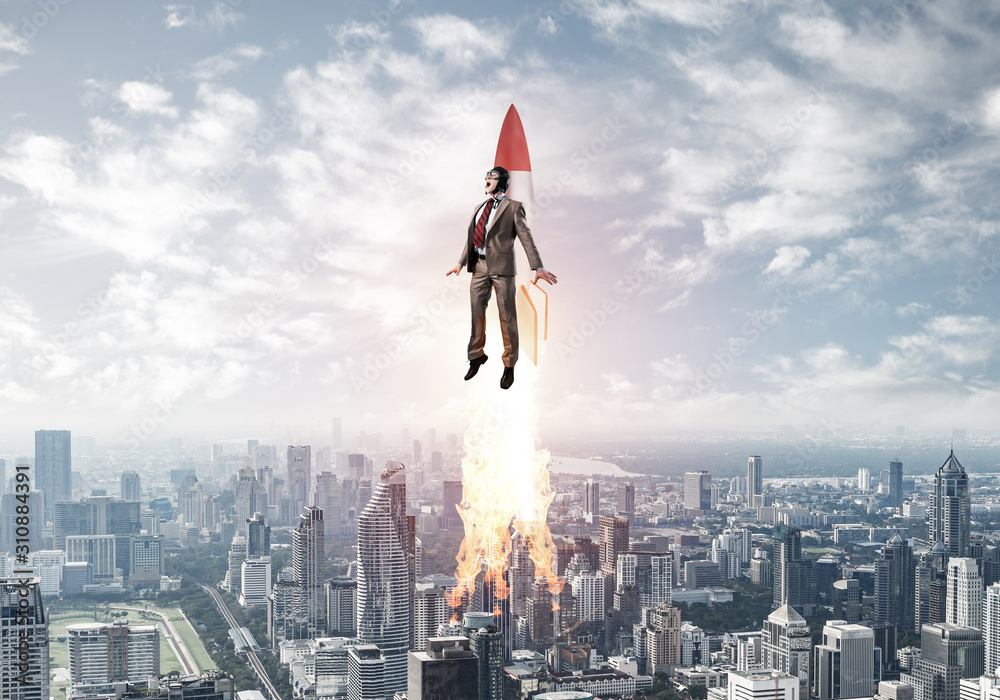 Business person in aviator hat flying on rocket Stock Photo | Adobe Stock