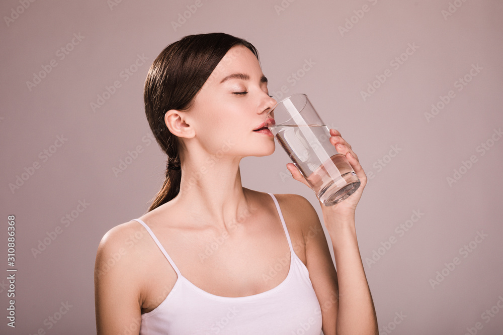 Side view of nice attractive young model drink water from glass. Take ...