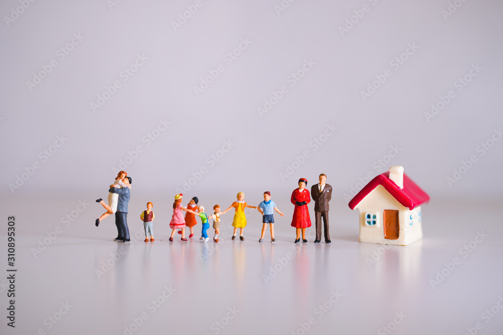 Miniature people, big family standing with mini house using as family ...