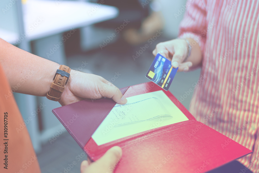 Staff showing bill or invoice that put on bill book for customer to ...