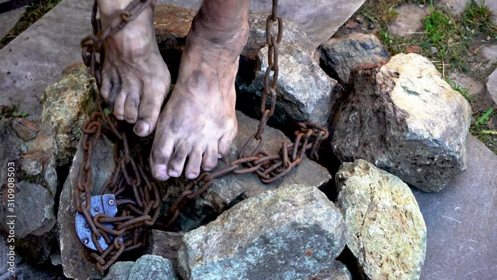 Vidéo Stock A slave in iron chains is trying to free himself. A scene ...