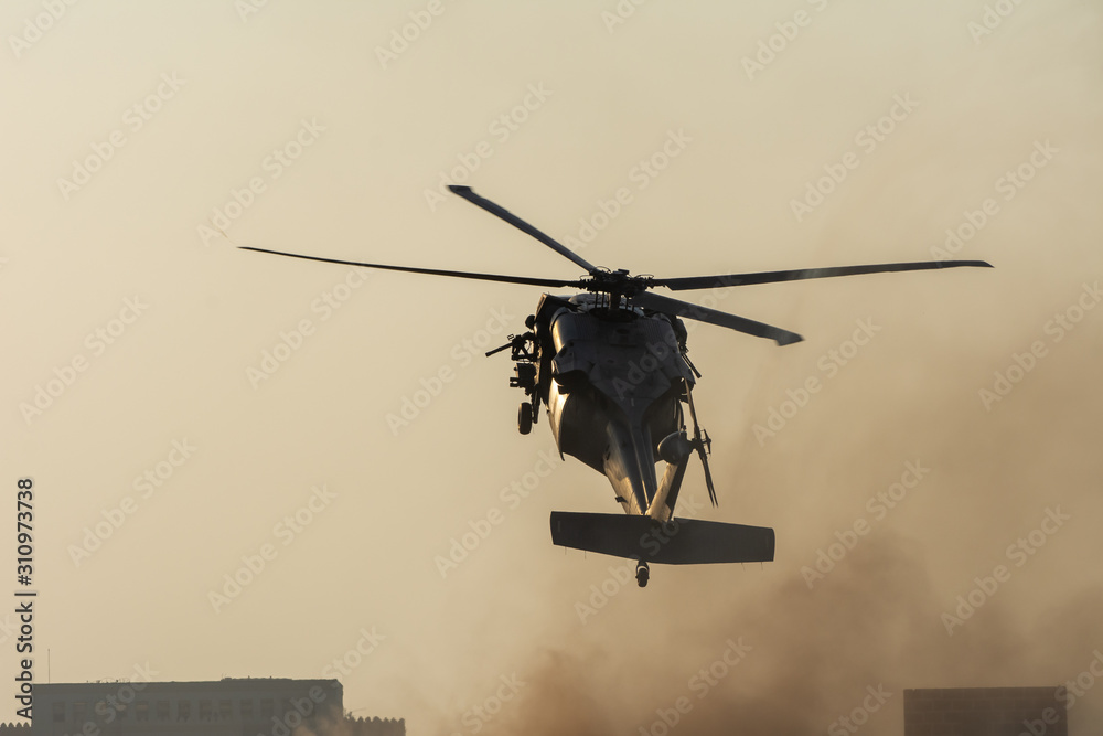 Military chopper takes off in combat and war flying into the smoke and ...