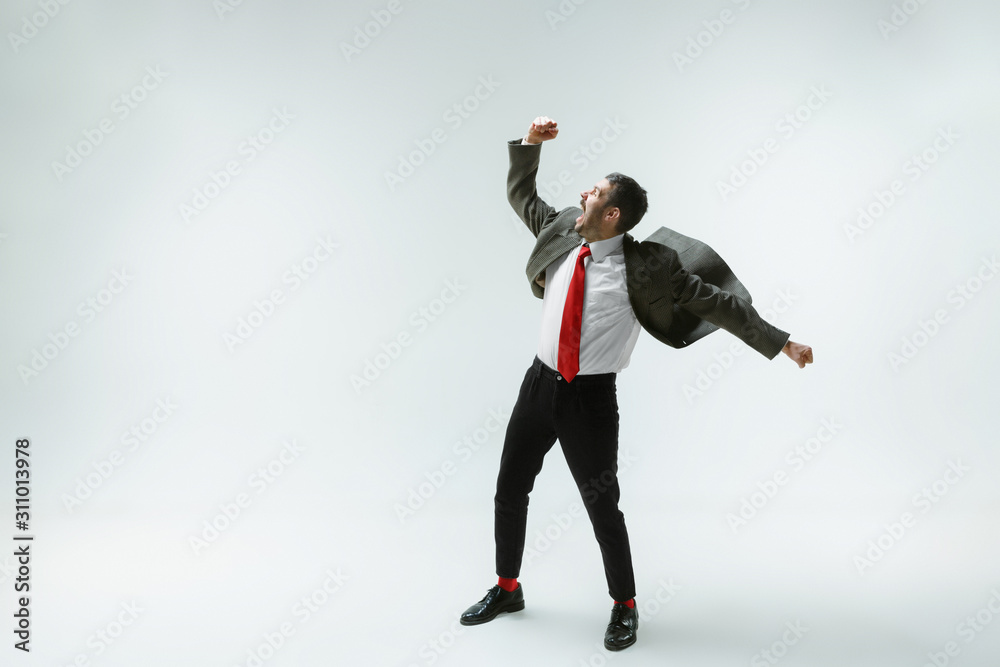 Young caucasian man moving flexible on white studio background. Male ...