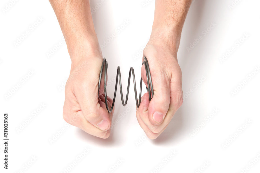 Man with two hands squeezes a spring on a white background. Stock Photo ...