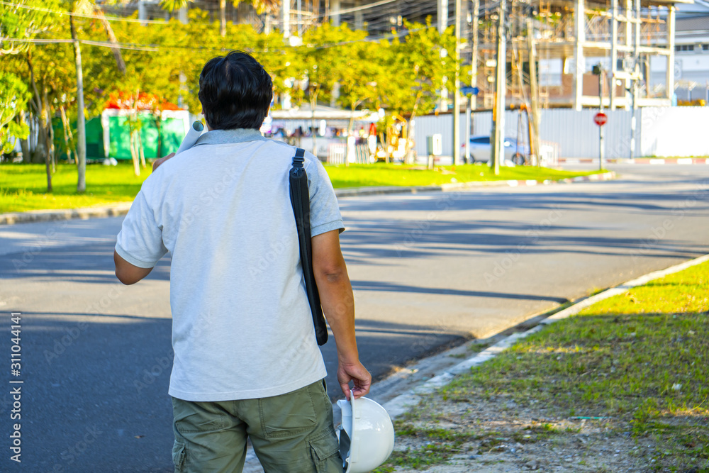 Engineer who is see plan to oversee construction site Stock Photo ...